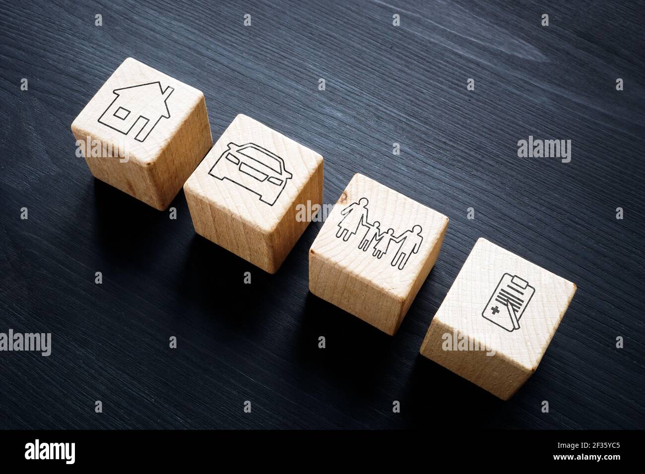 Wooden cubes with car, home, family and medical insurance symbols Stock ...