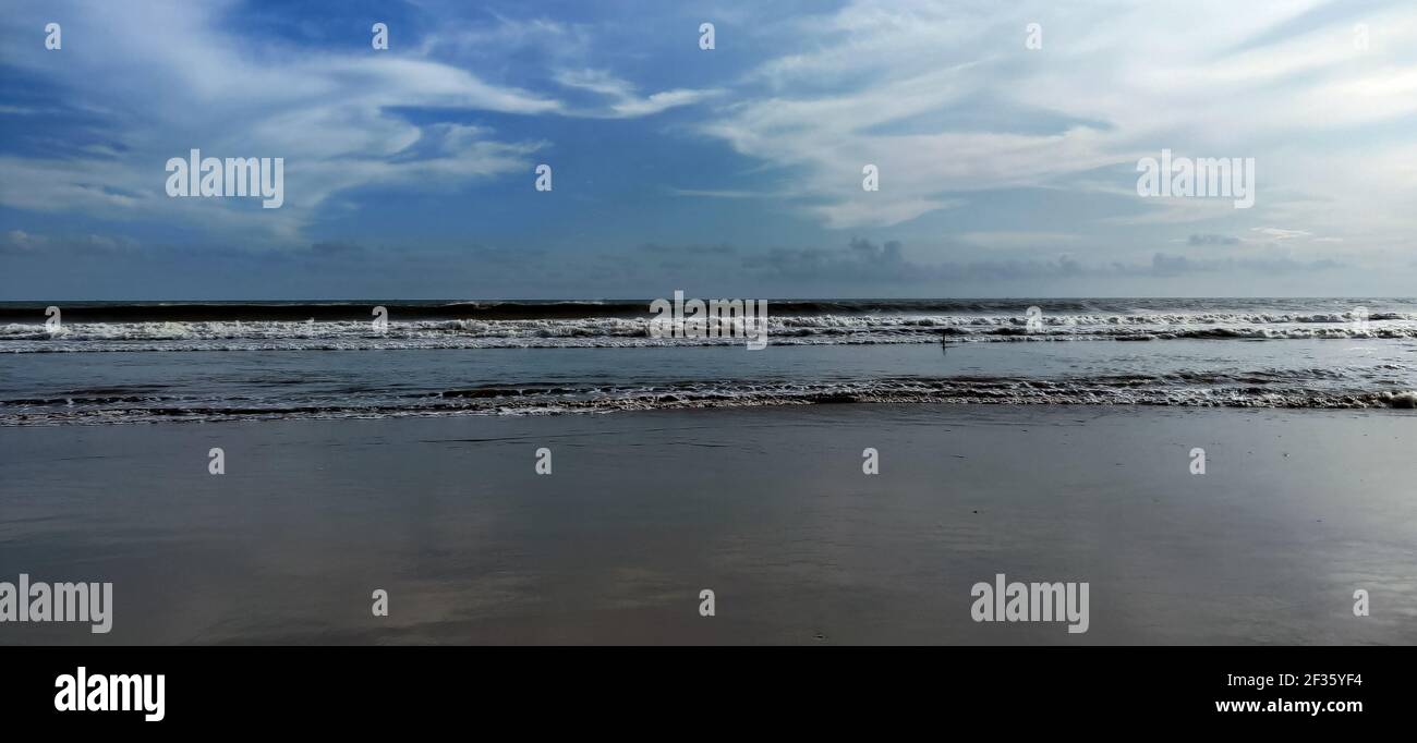 A beautiful scene of sea waves rushing into the sandy shore Stock Photo ...