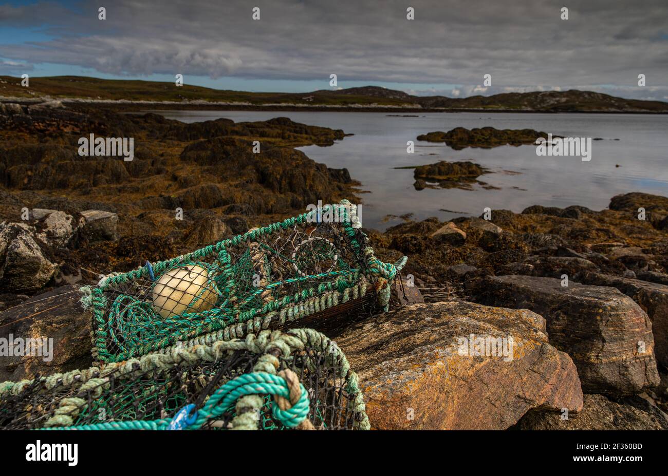 Fishing traps in the anchored in a small harbour in North Uist in the ...