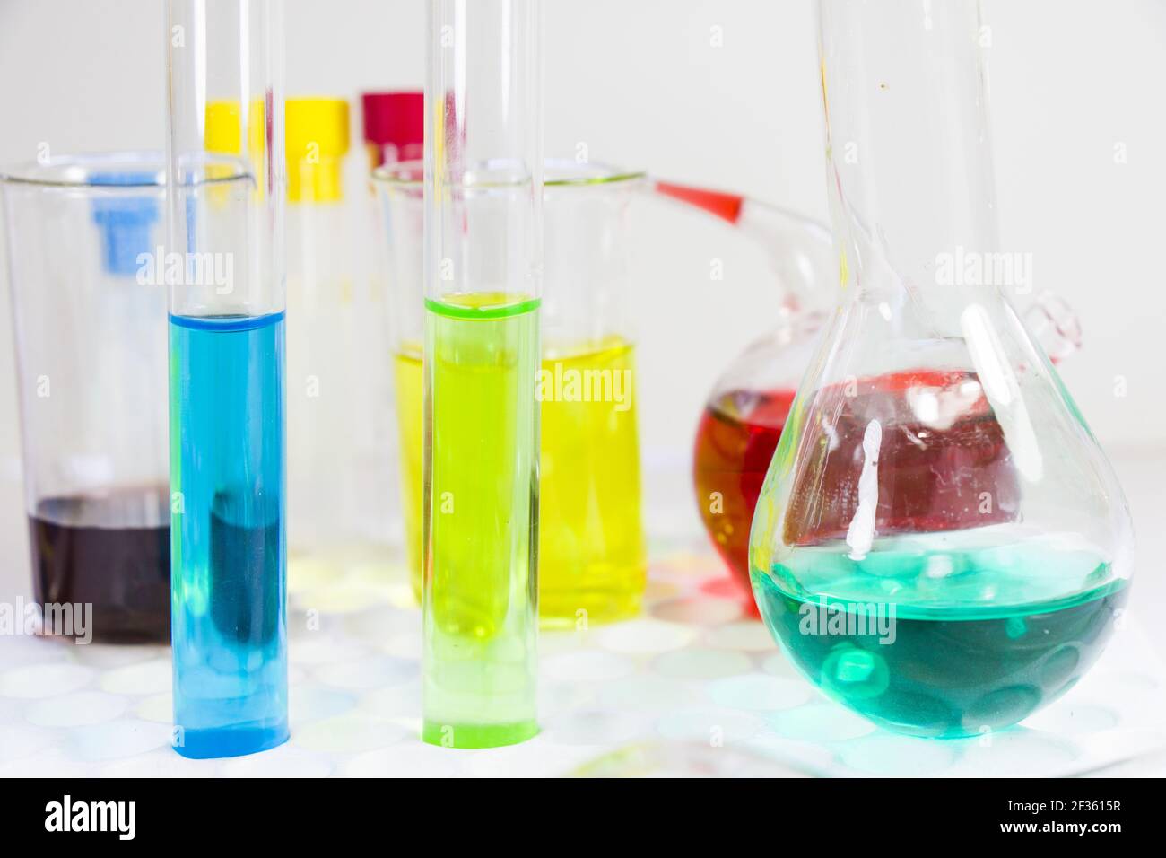 A view of laboratory glassware with colorful chemical liquid elements ...