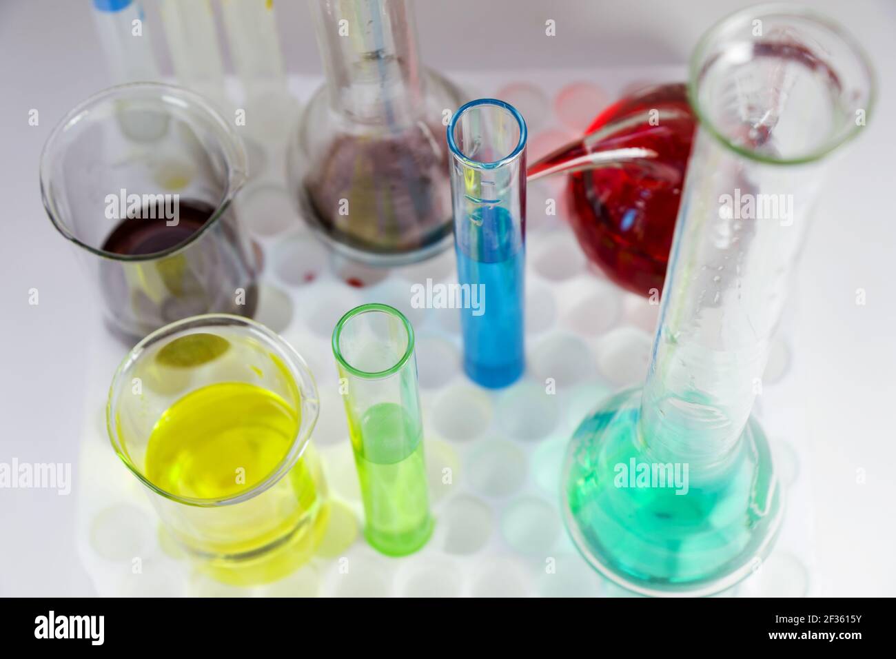 A top view of laboratory glassware with colorful chemical liquid ...