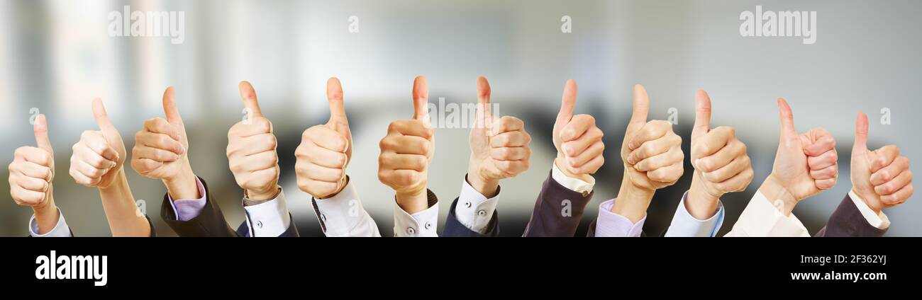 Business people with thumbs up in the office Stock Photo - Alamy