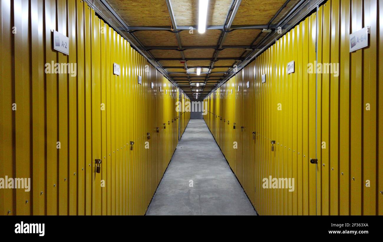 Hallway with yellow storage units. Concrete floor Stock Photo - Alamy