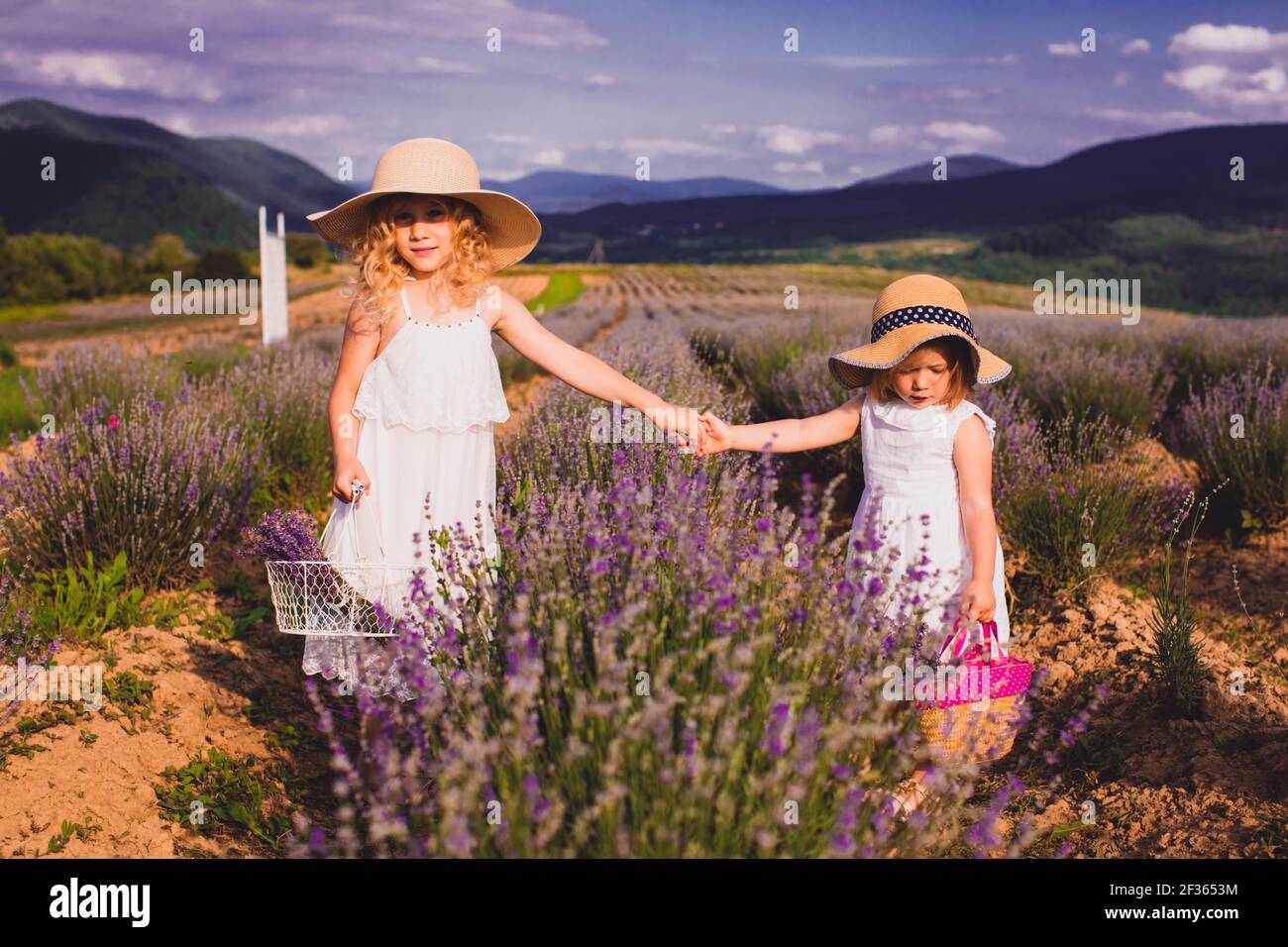 Two cute sisters travel through beautiful nature Stock Photo - Alamy