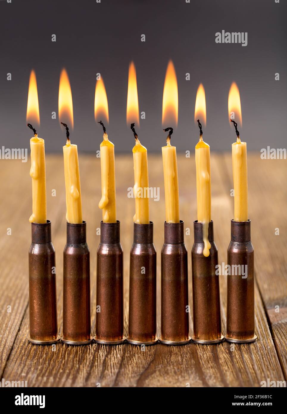 Burning candles and empty rifle cartridges. As a symbol of war and ...