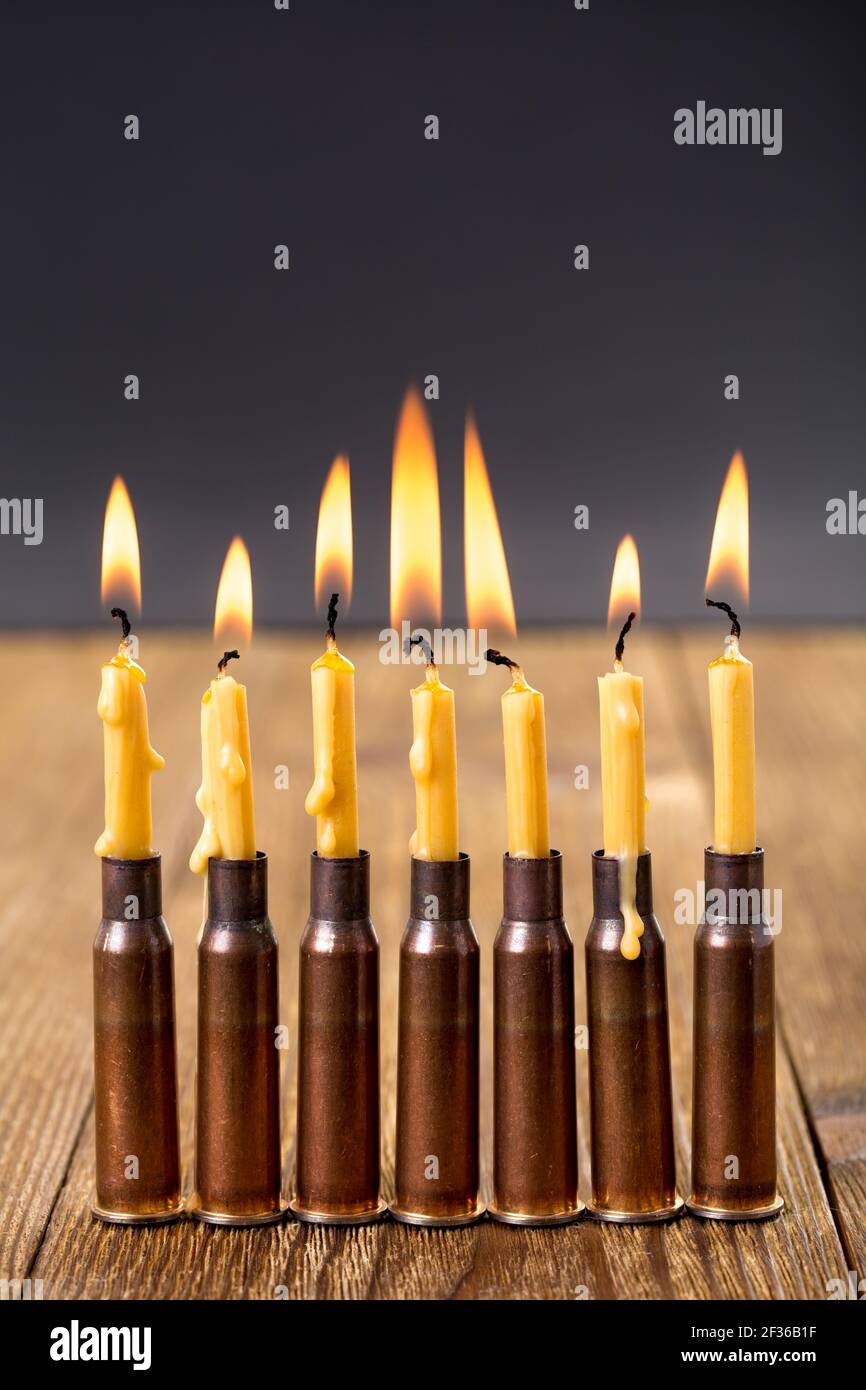Burning candles and empty rifle cartridges. As a symbol of war and ...