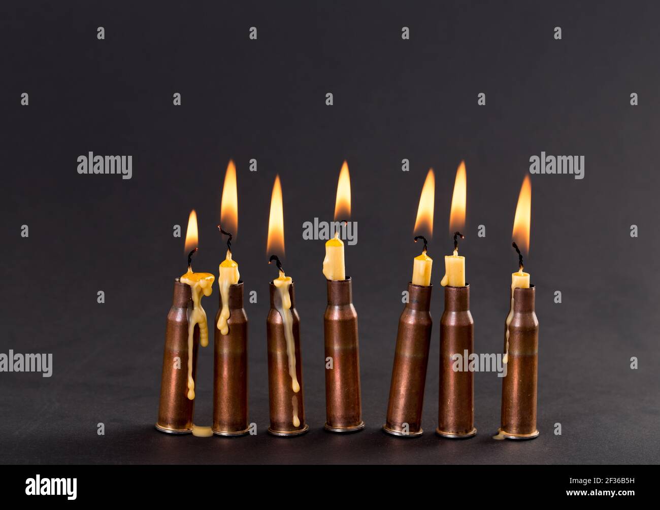 Burning candles and empty rifle cartridges. As a symbol of war and ...