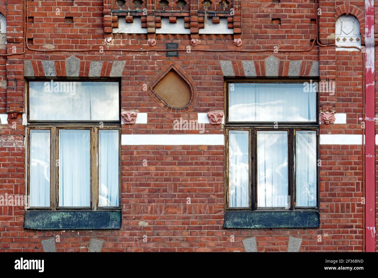 Two rectangular windows with old wooden frames on the background of an ...