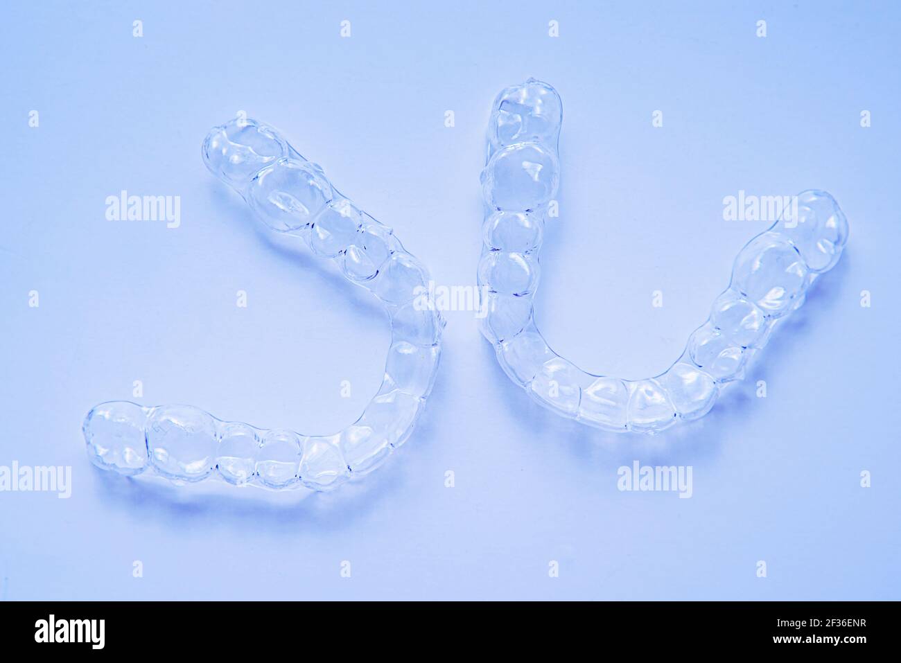Invisible dental teeth brackets tooth aligners on blue background ...