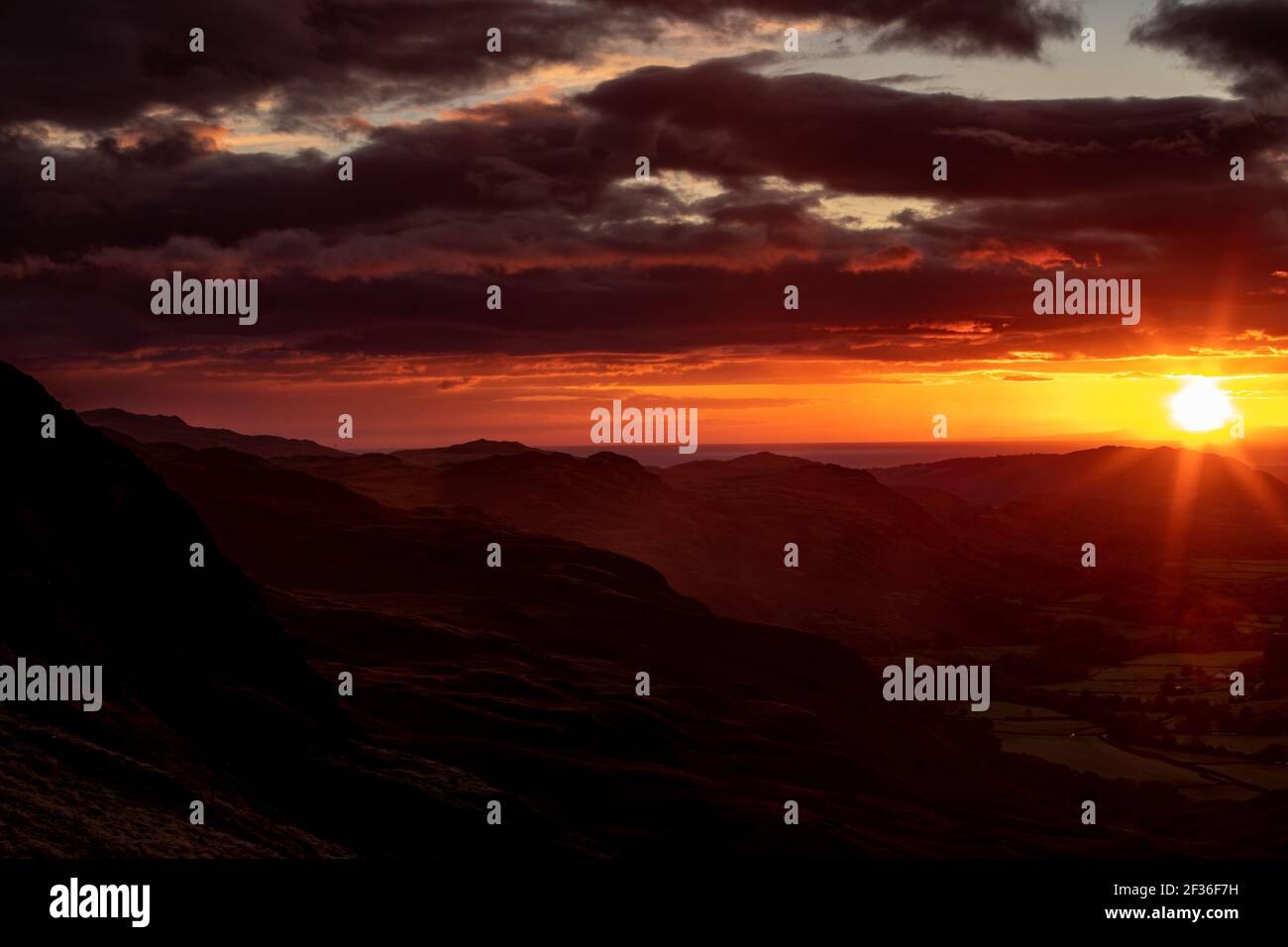 General view sun lighting up the horizon from Hardknott Pass in the ...