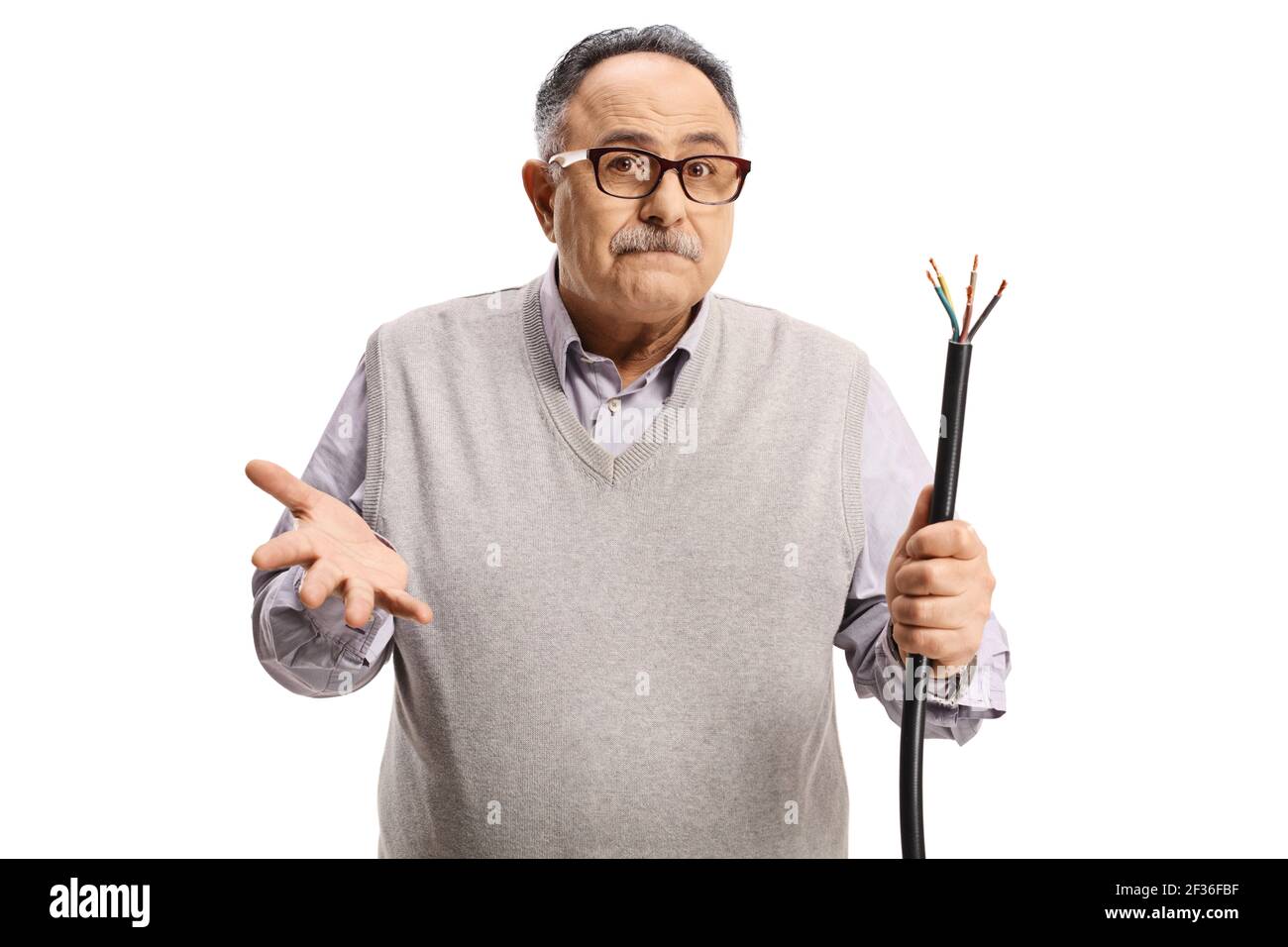 Confused mature man holding a broken elecrtic cable and looking at ...