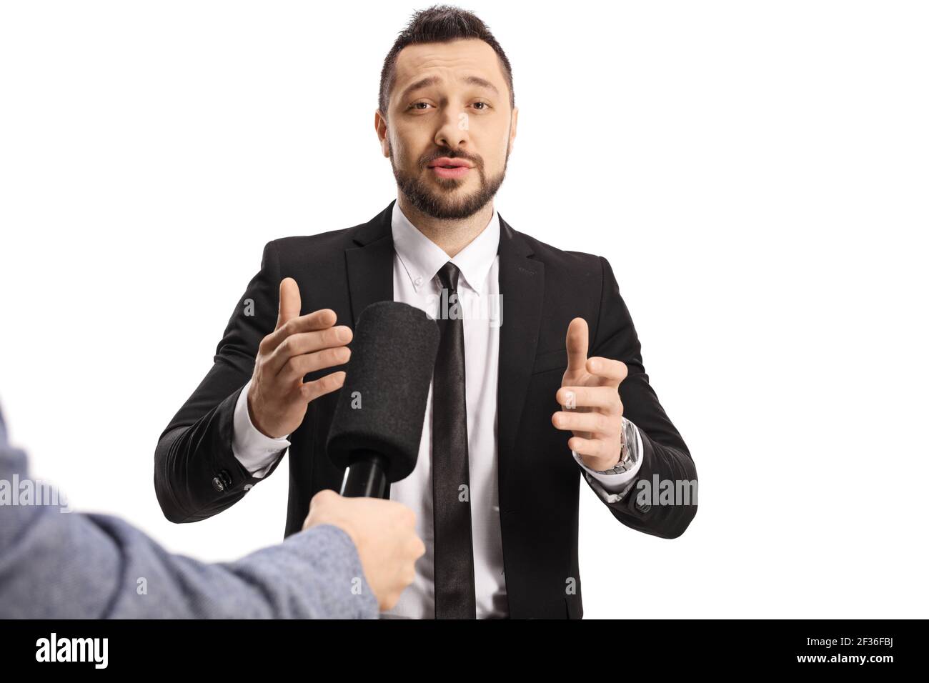 Interview with a young man in a suit and tie isolated on white ...