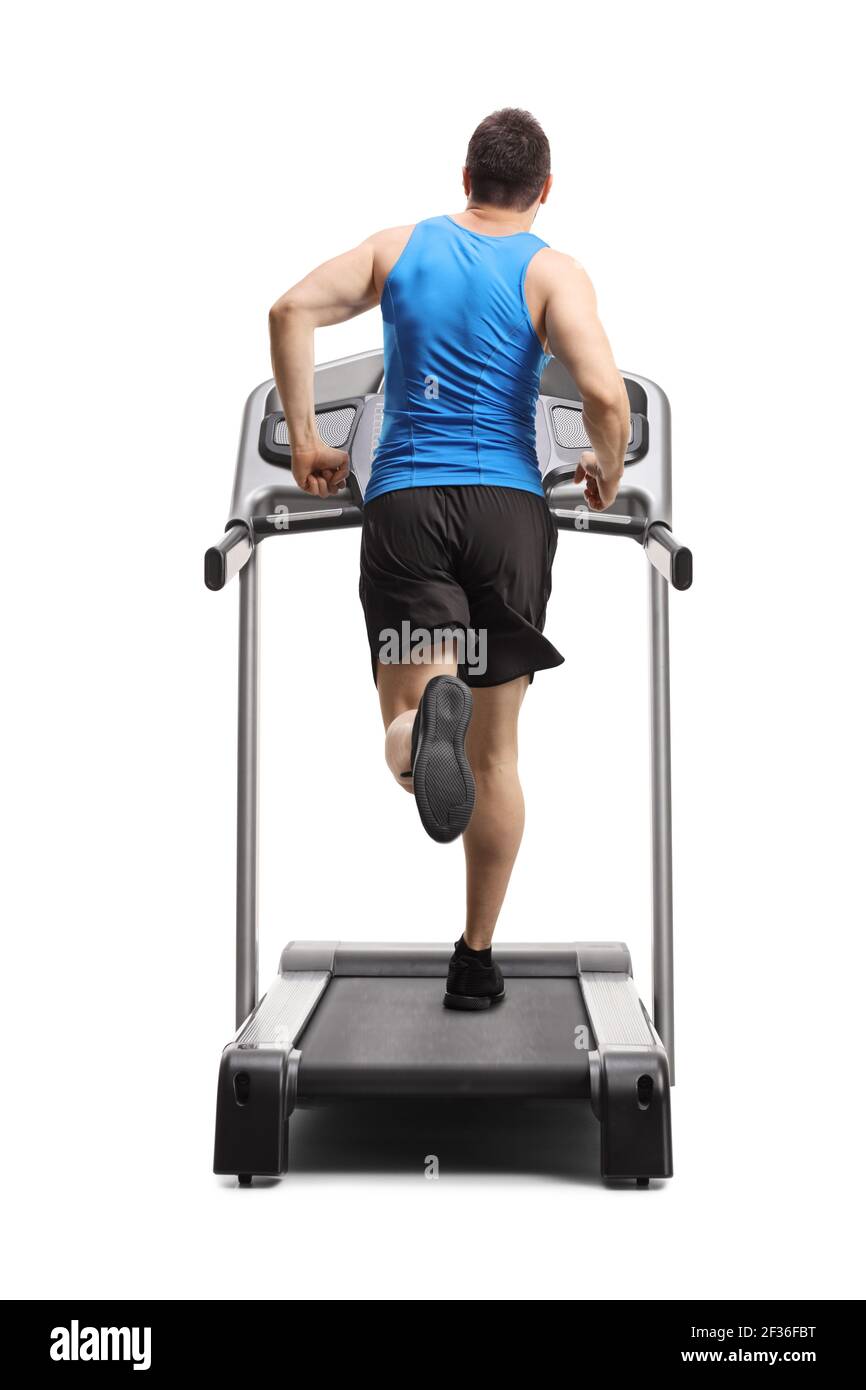 Rear shot of a fit man running on a treadmill isolated on white ...