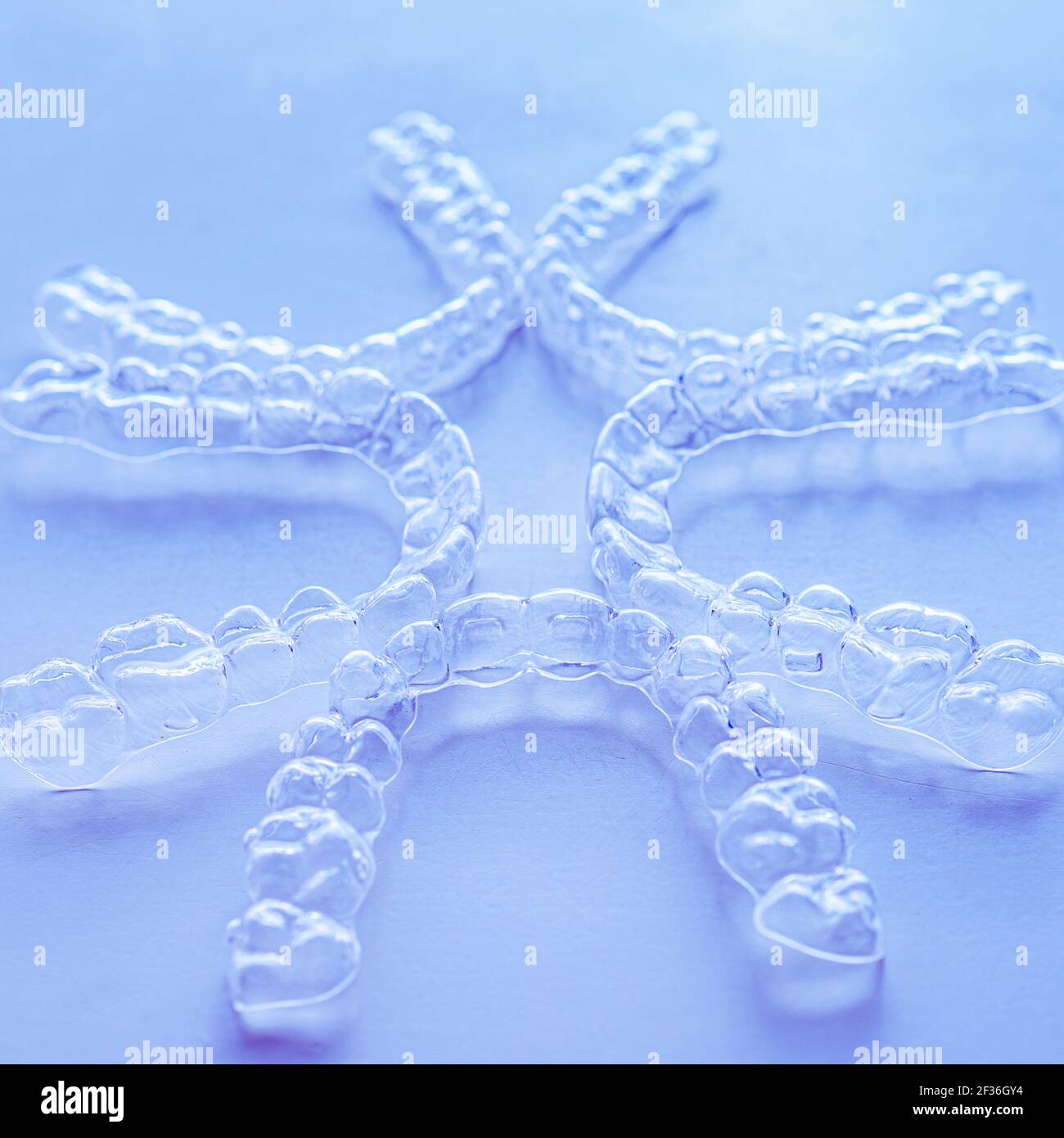 Invisible dental teeth brackets tooth aligners on blue background ...