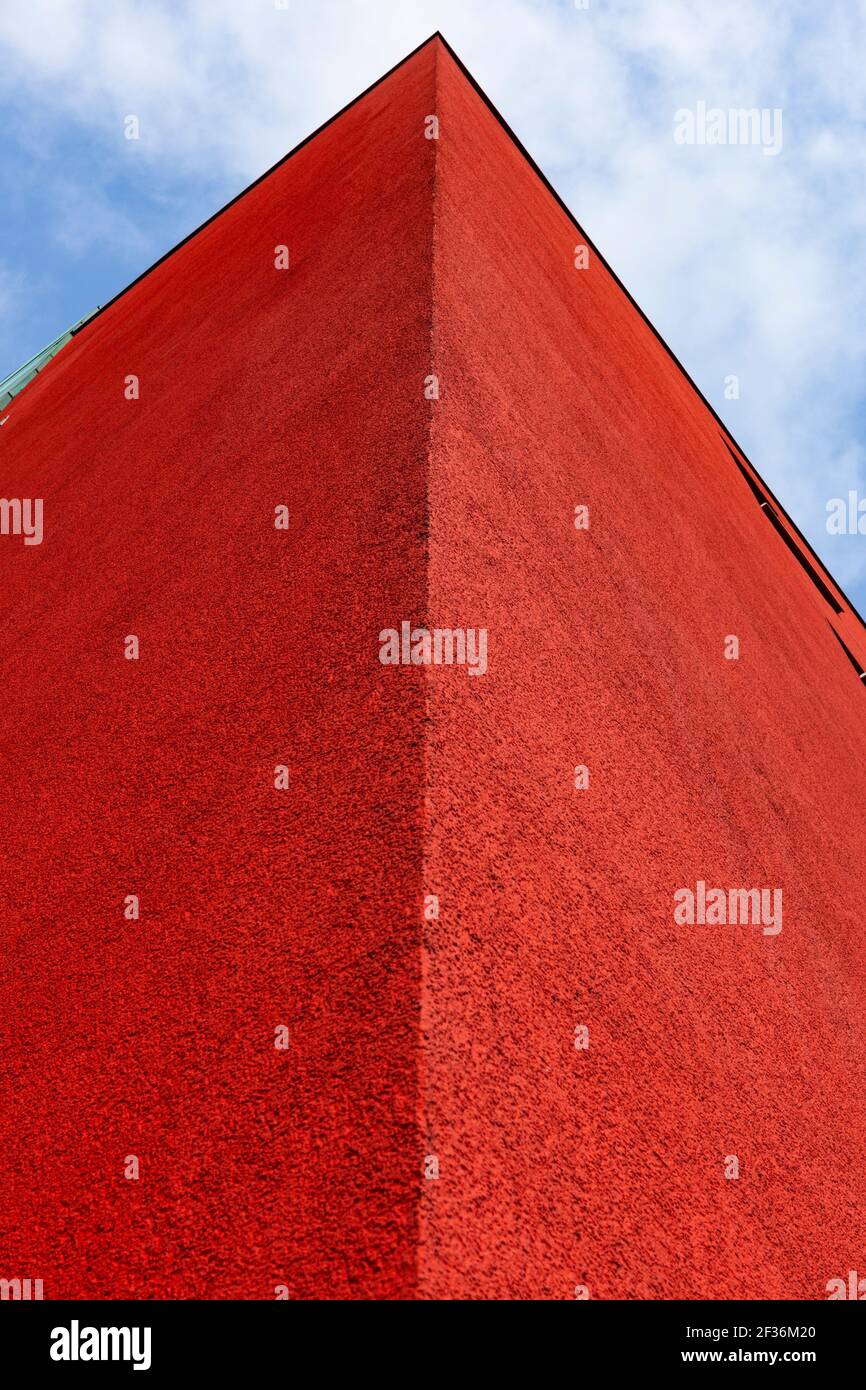 The photo shows a red corner of a modern building Stock Photo - Alamy