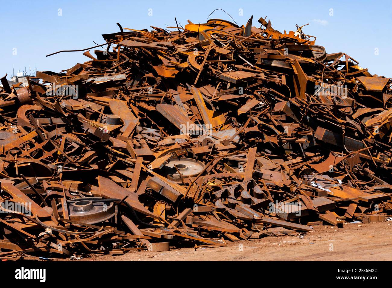 The photo shows a large, rusty pile of scrap metal in the sun Stock ...