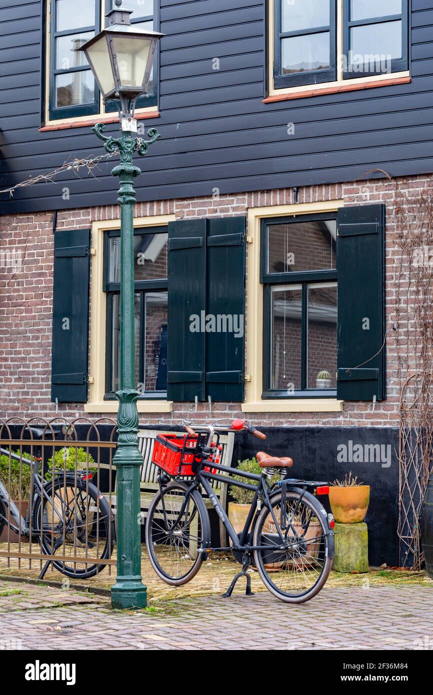 Dutch male bike in front of wooden house Stock Photo - Alamy