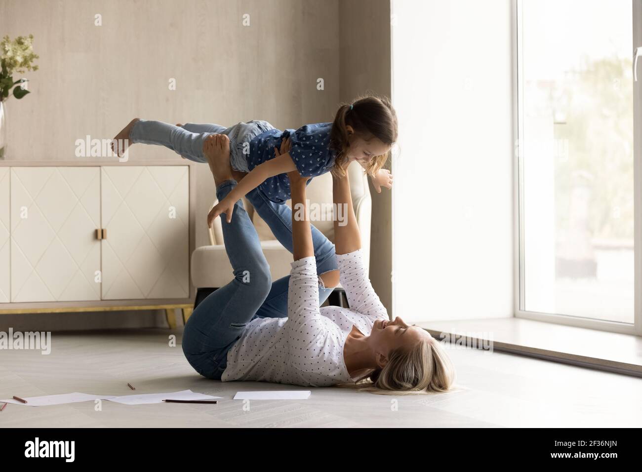 Happy mom and little daughter play together at home Stock Photo - Alamy