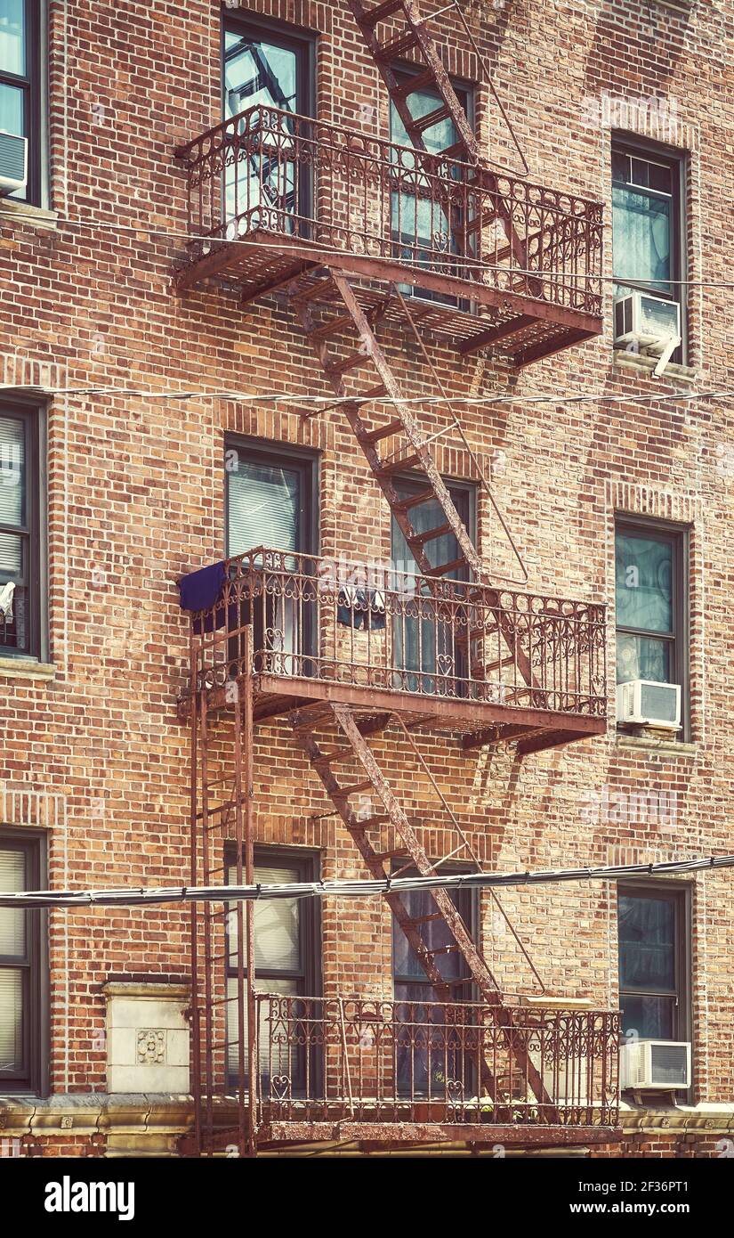 Old brick house building with iron fire escape, color toned picture ...