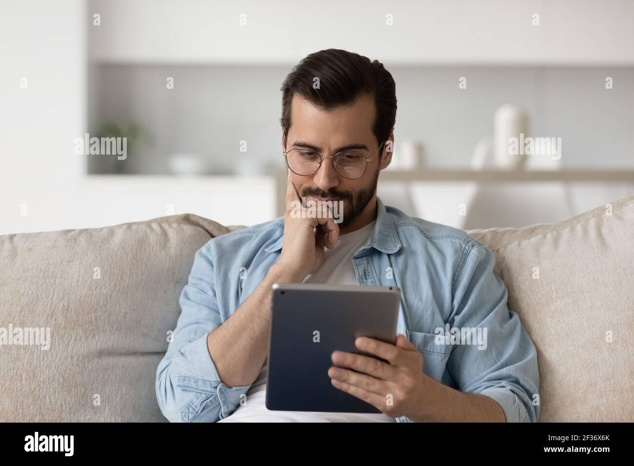 Pensive caucasian guy thinking home hi-res stock photography and images ...
