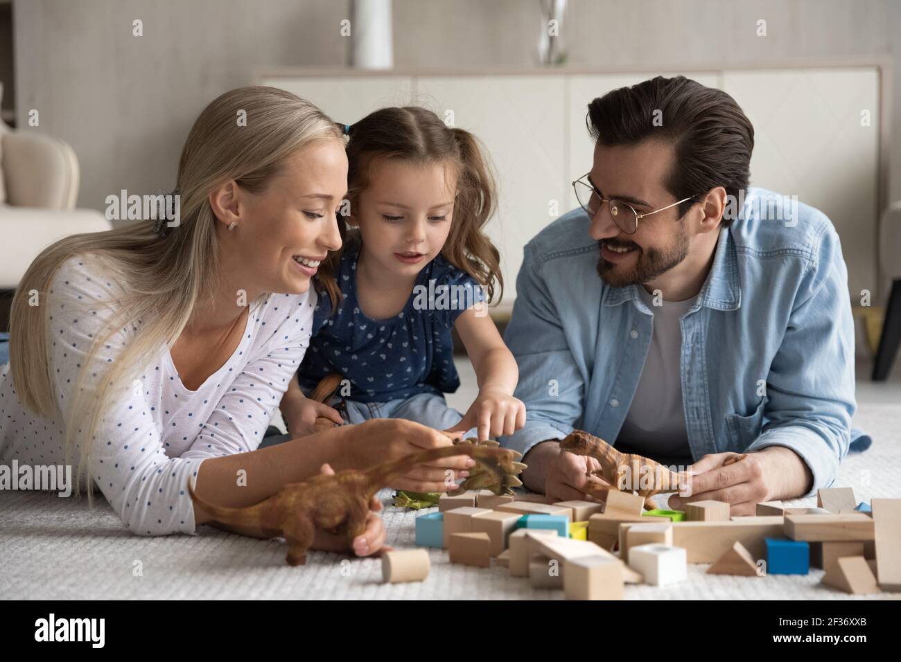 Happy family with daughter play together at home Stock Photo - Alamy