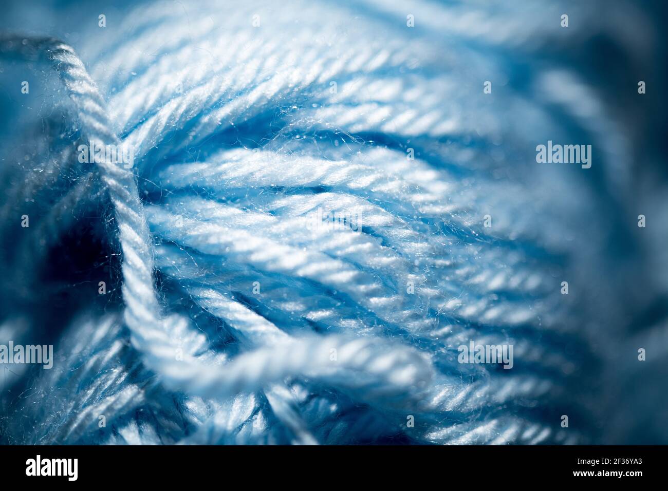 An extreme close-up with selective focus of blue and fuzzy bundled ...