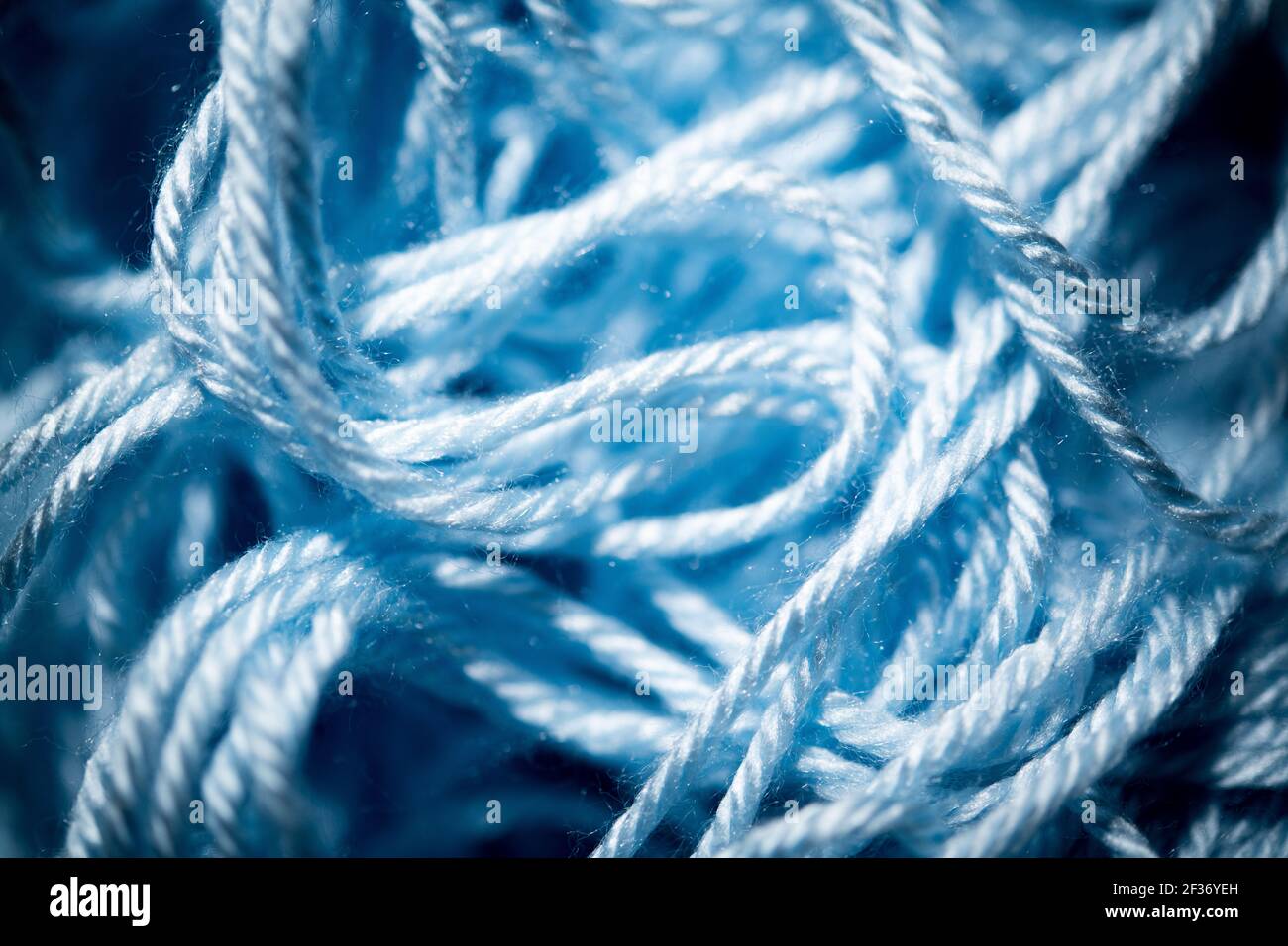 An extreme close-up with selective focus of blue and fuzzy bundled ...