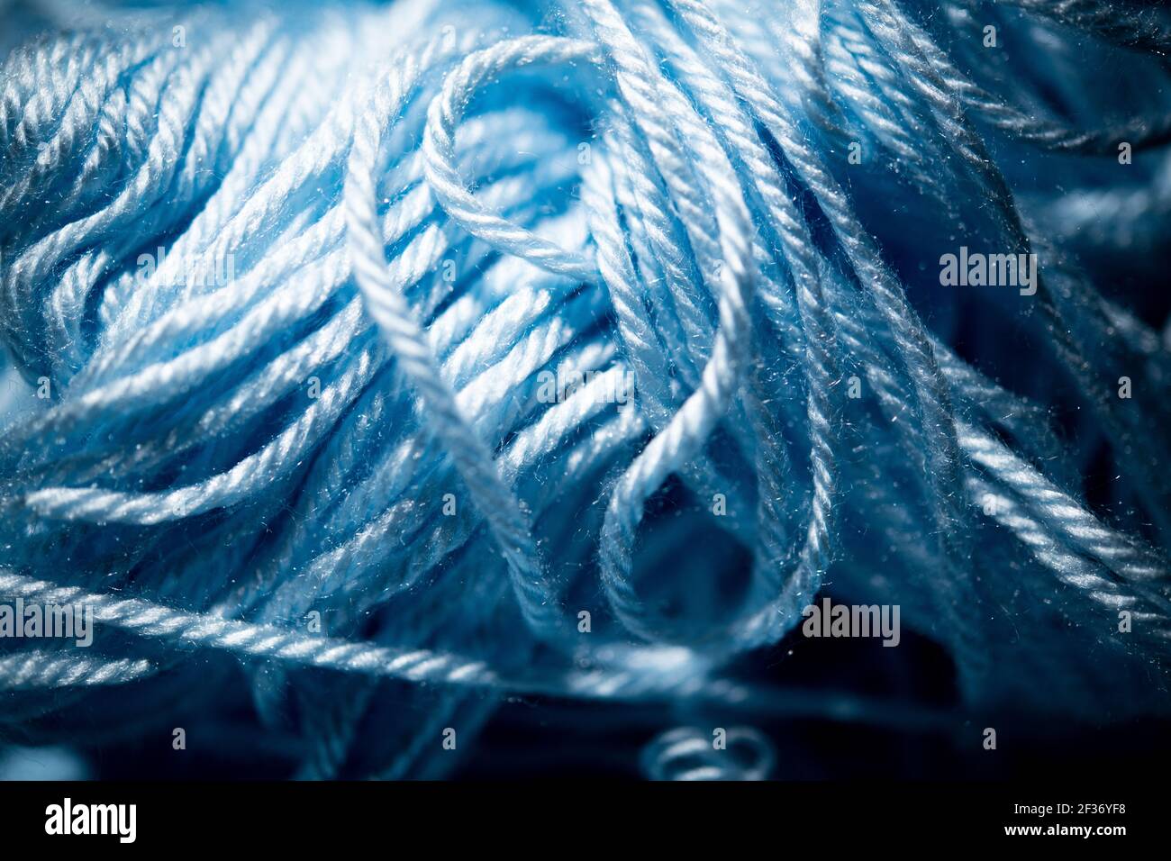 An extreme close-up with selective focus of blue and fuzzy bundled ...