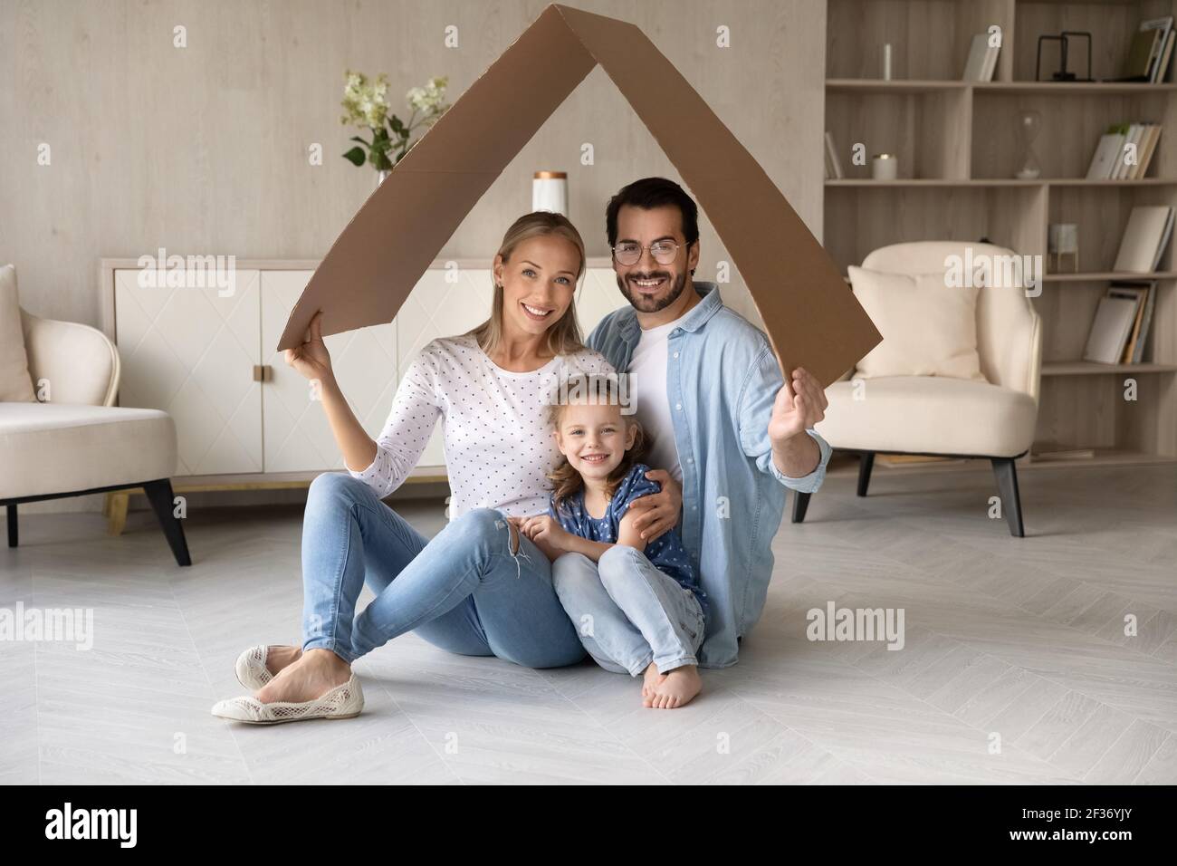 Portrait of happy family with kid celebrate relocation Stock Photo - Alamy