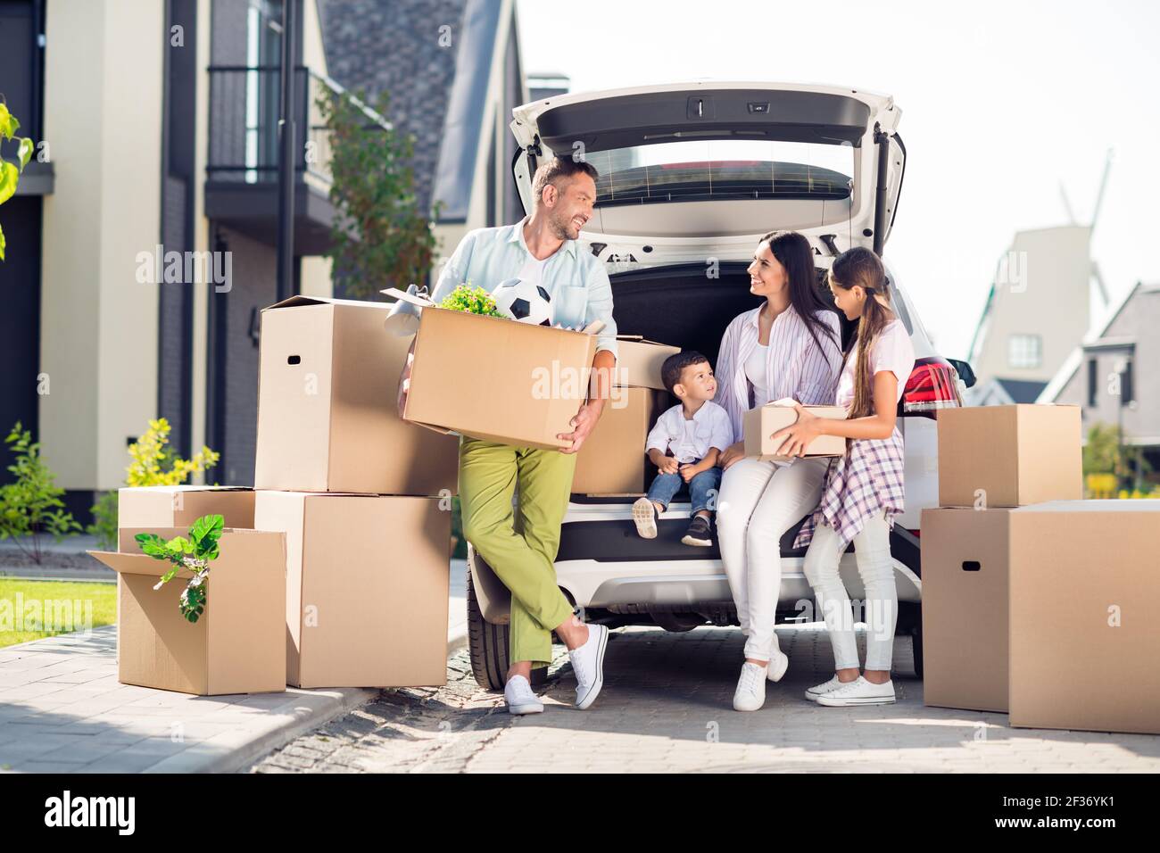Full size photo of happy smiling family moving dad pack stuff mom and ...