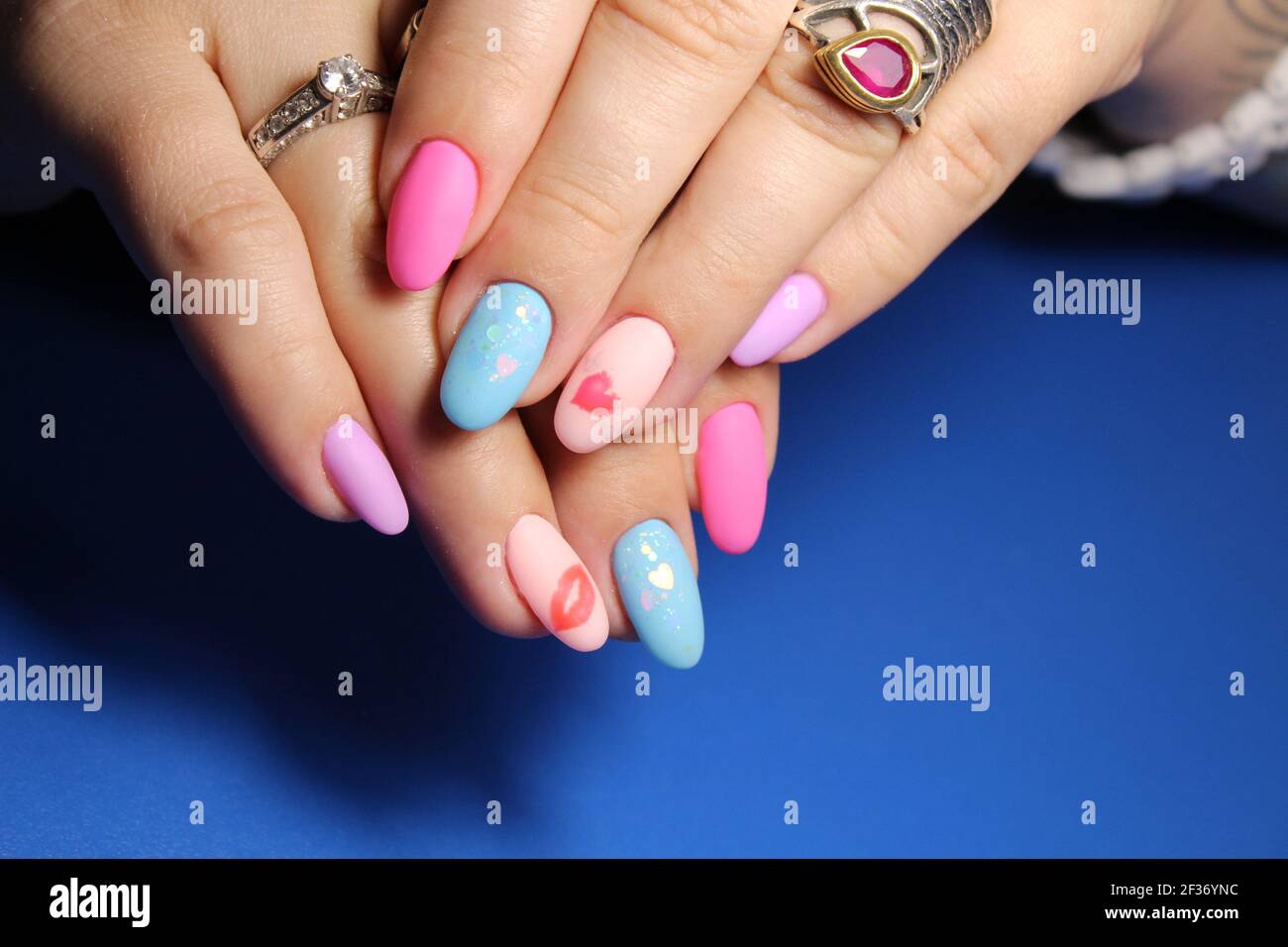 A closeup shot of female hands with a beautiful trendy gel art design ...