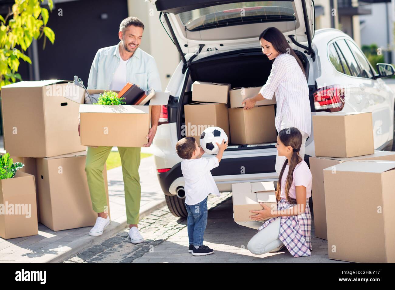 Full size photo of smiling happy family moving pack stuff dad mom and ...