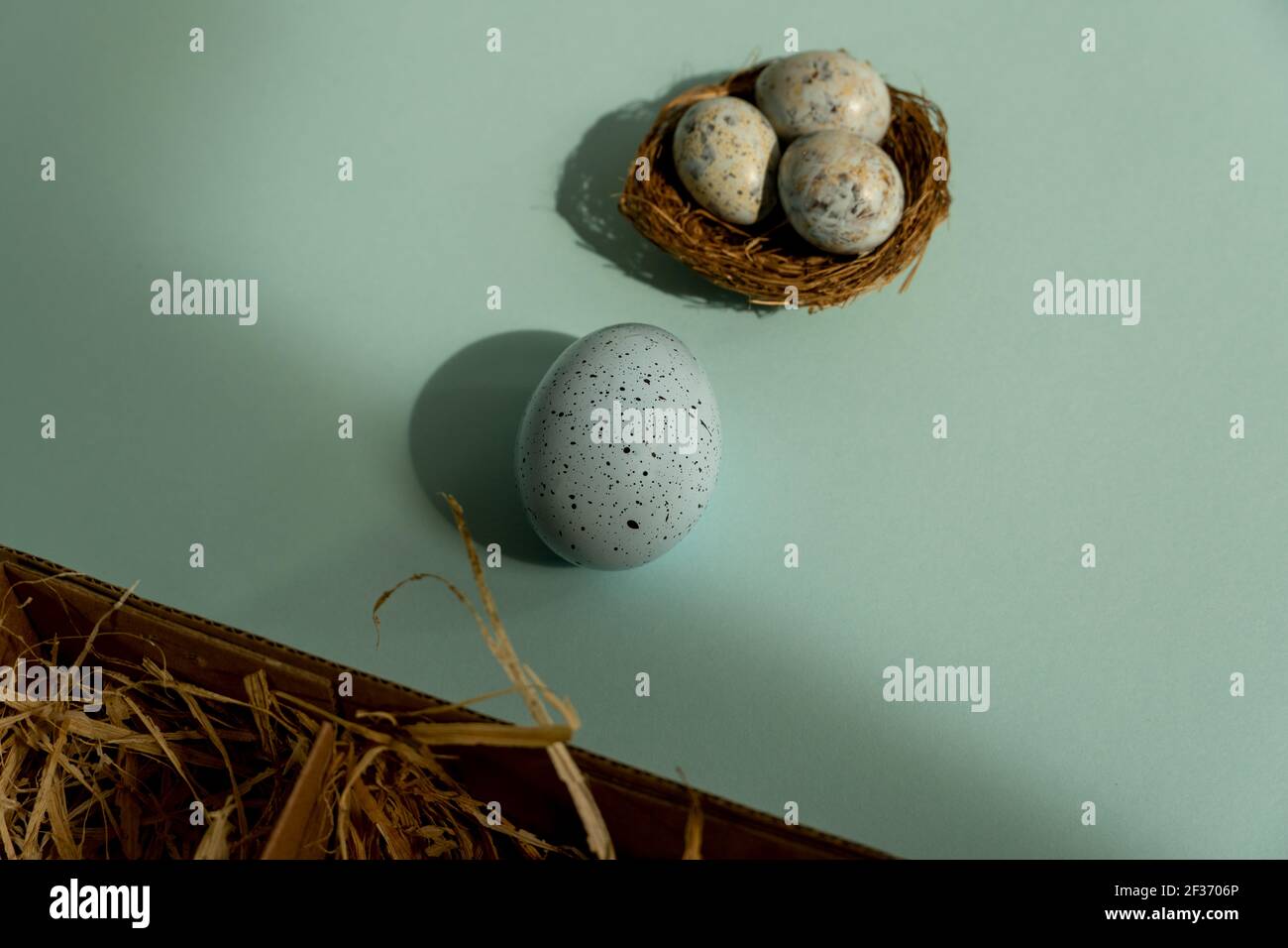Easter egg on a blue background and and three small blue eggs in the ...