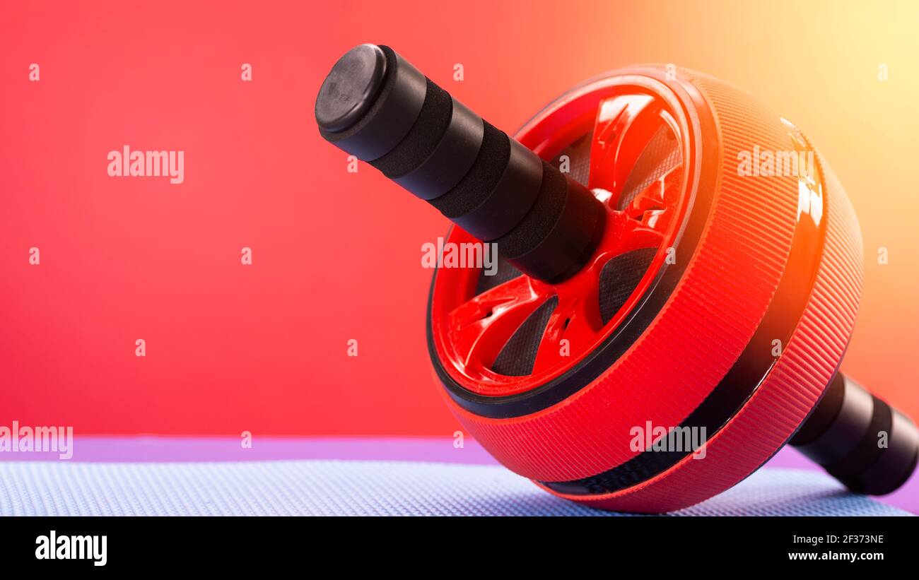 Abdominal roller, abdominal exercises, strength trainer on a mat on a ...