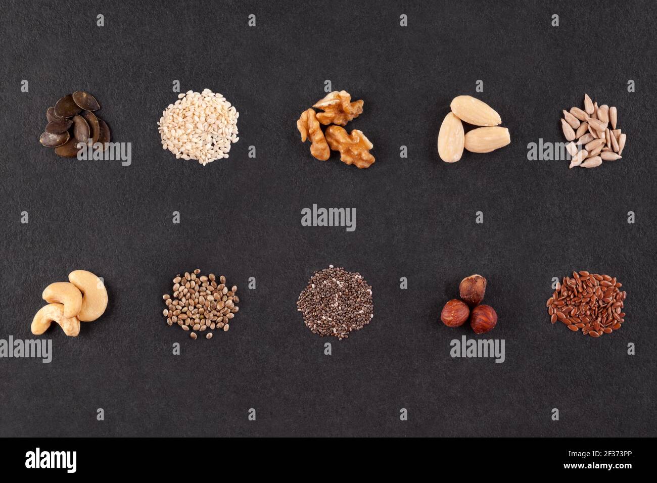 Various seeds and nuts on table. Flax, hemp, sunflower, sesame, chia ...