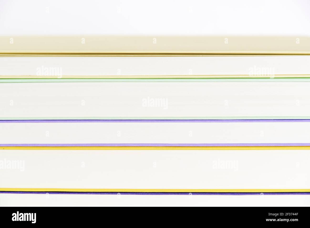 Geometric background, close-up front view of a stack of books. Colored ...