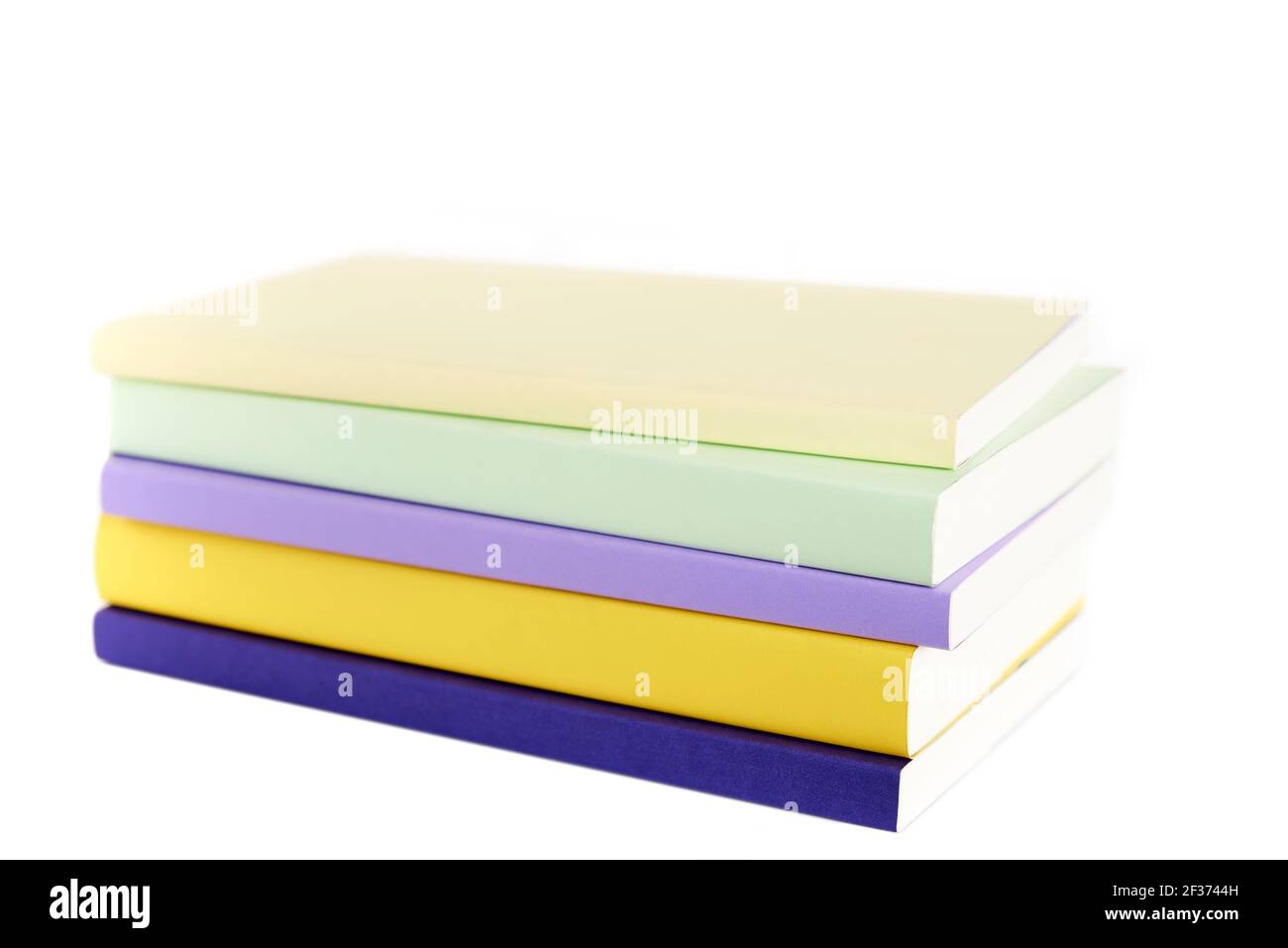 Colored books with blank spine stacked, isolated on a white background ...