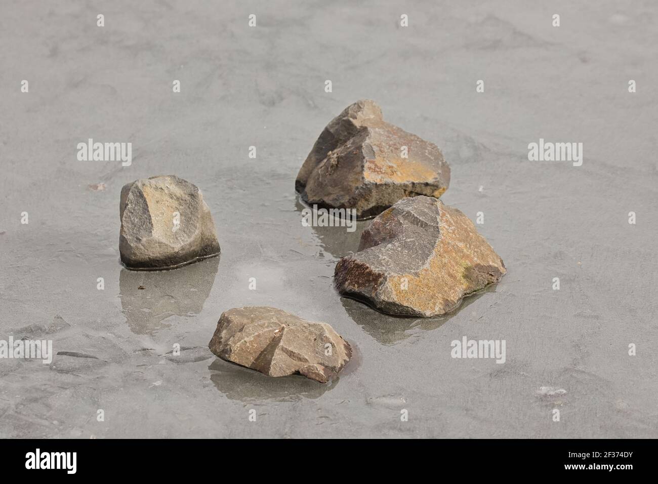 An abstract photo of rocks laying on melting ice in Hauser, Idaho Stock ...