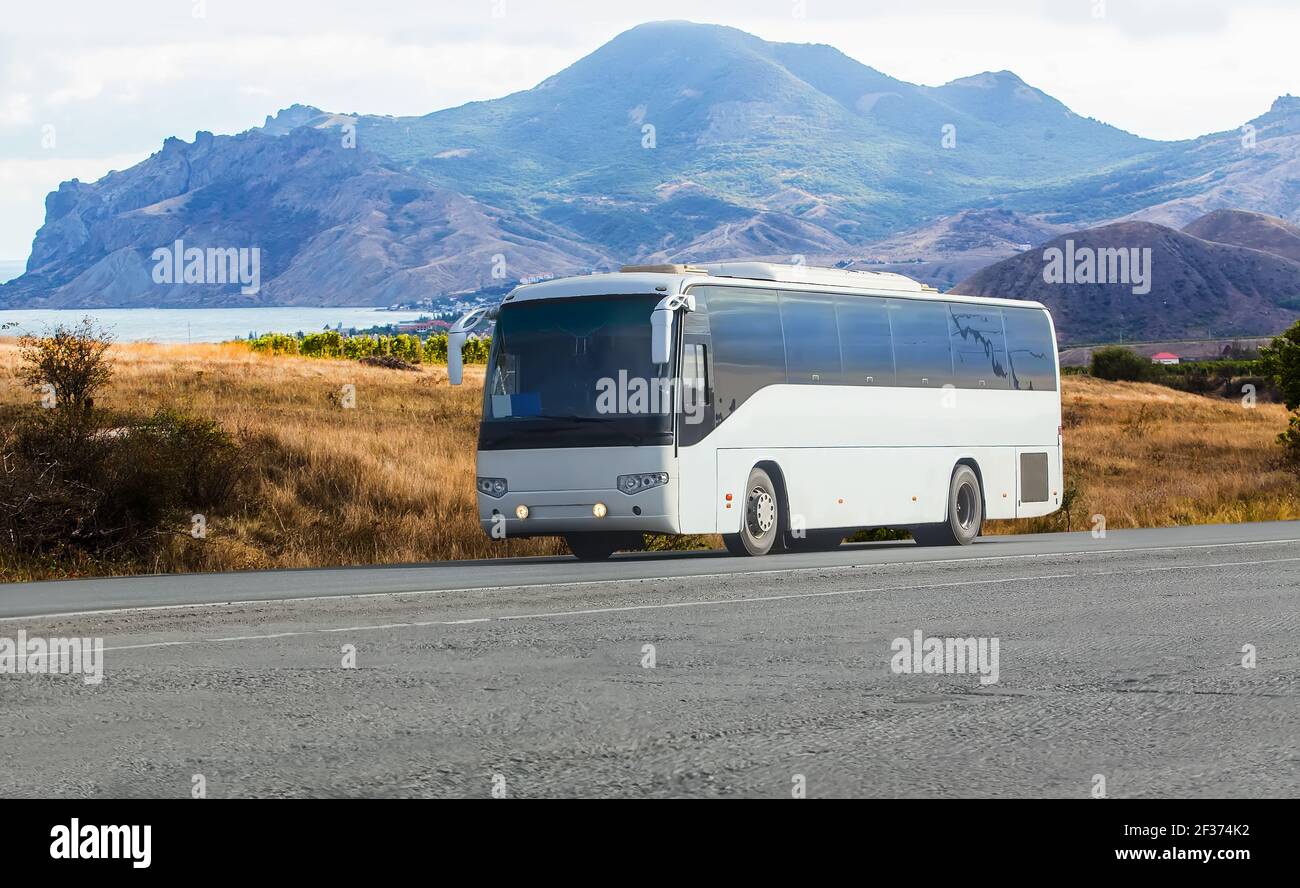 Tourist Bus Rides on the Picturesque mountain highway Stock Photo - Alamy