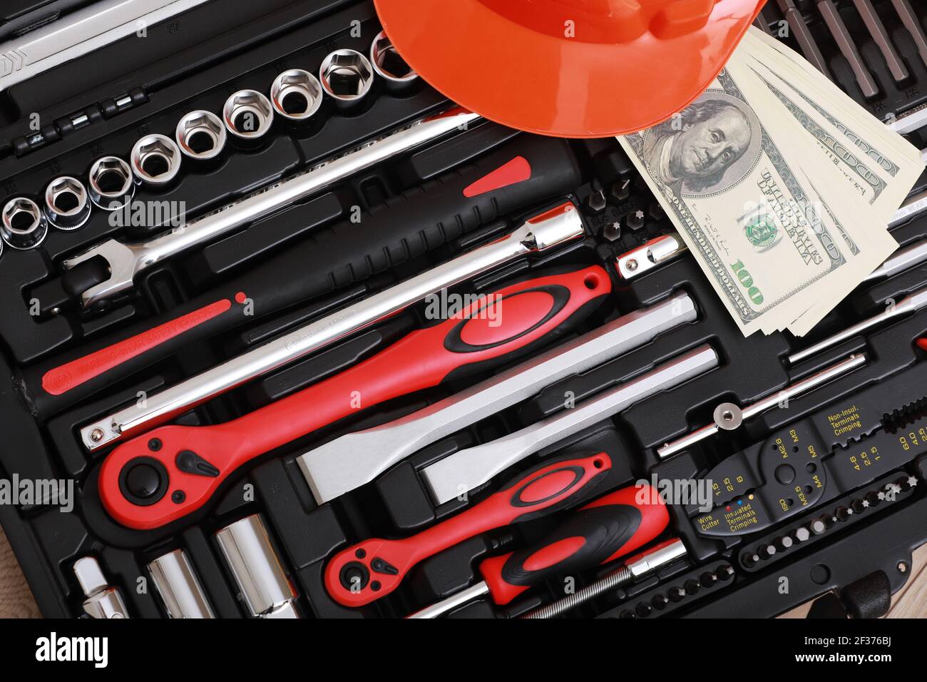 Toolbox, tools kit detail, dollar bills and orange protective helmet ...