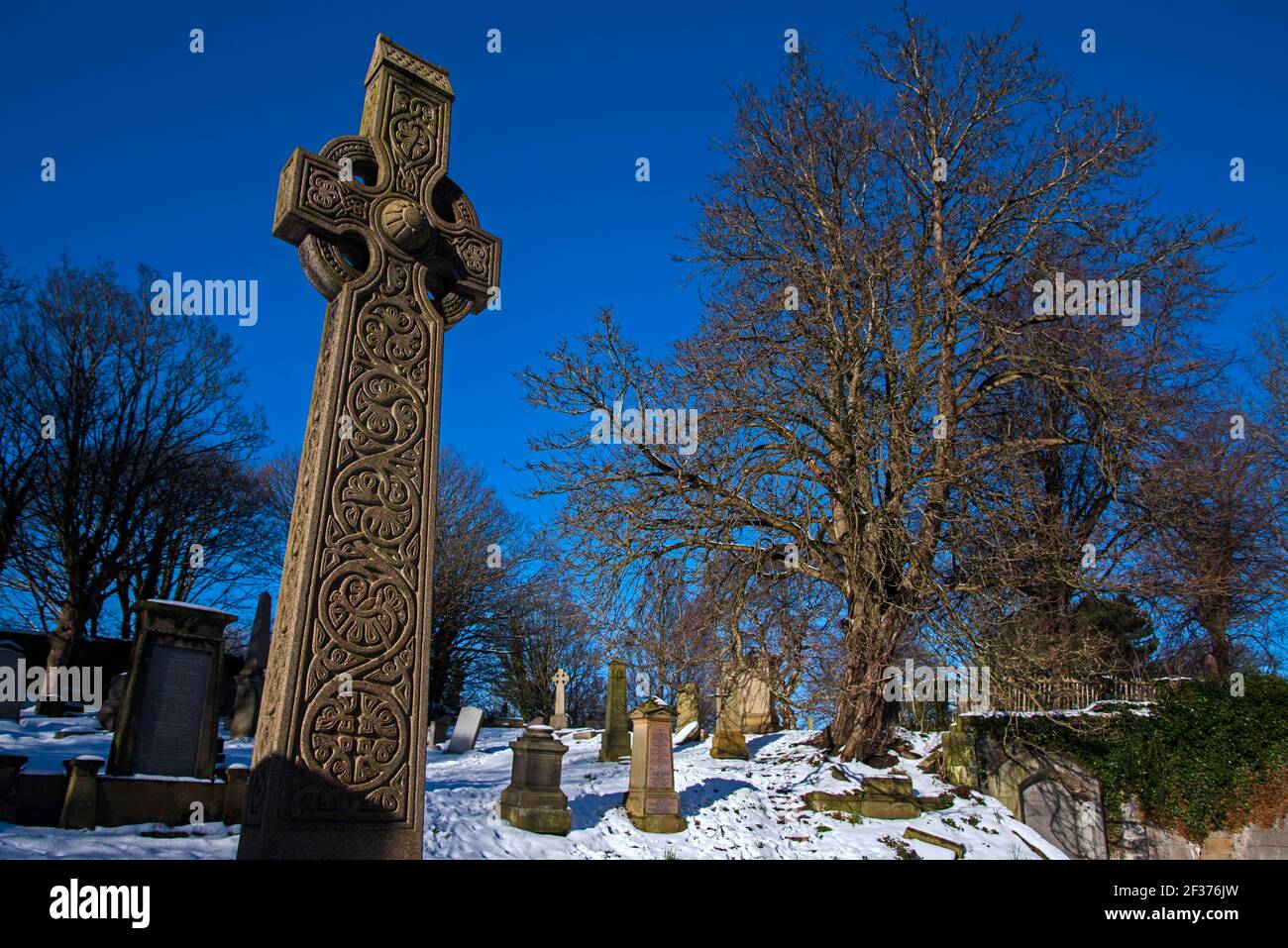 Celtic Cross against a blue sky in a wintry Warriston Cemetery ...