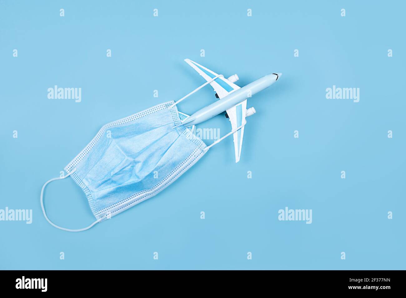 Airplane in flight with a medical mask. Concept - observance of safety ...