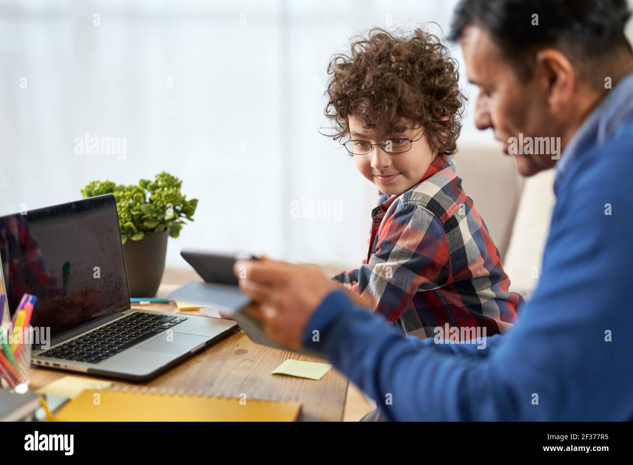 Teaching kid. Portrait of cute little hispanic school boy doing ...