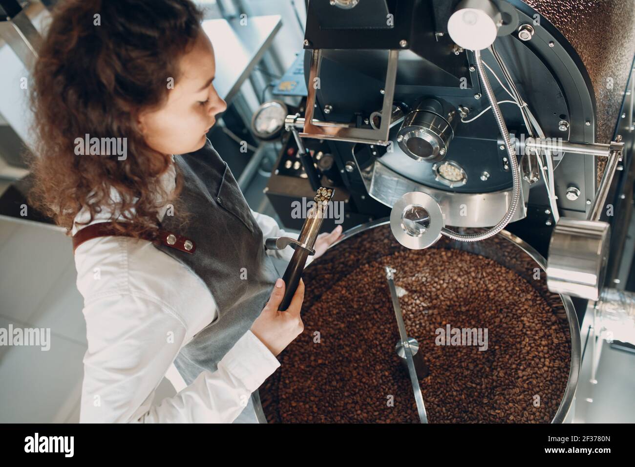 Coffee roaster machine and barista with tryer at coffee roasting ...