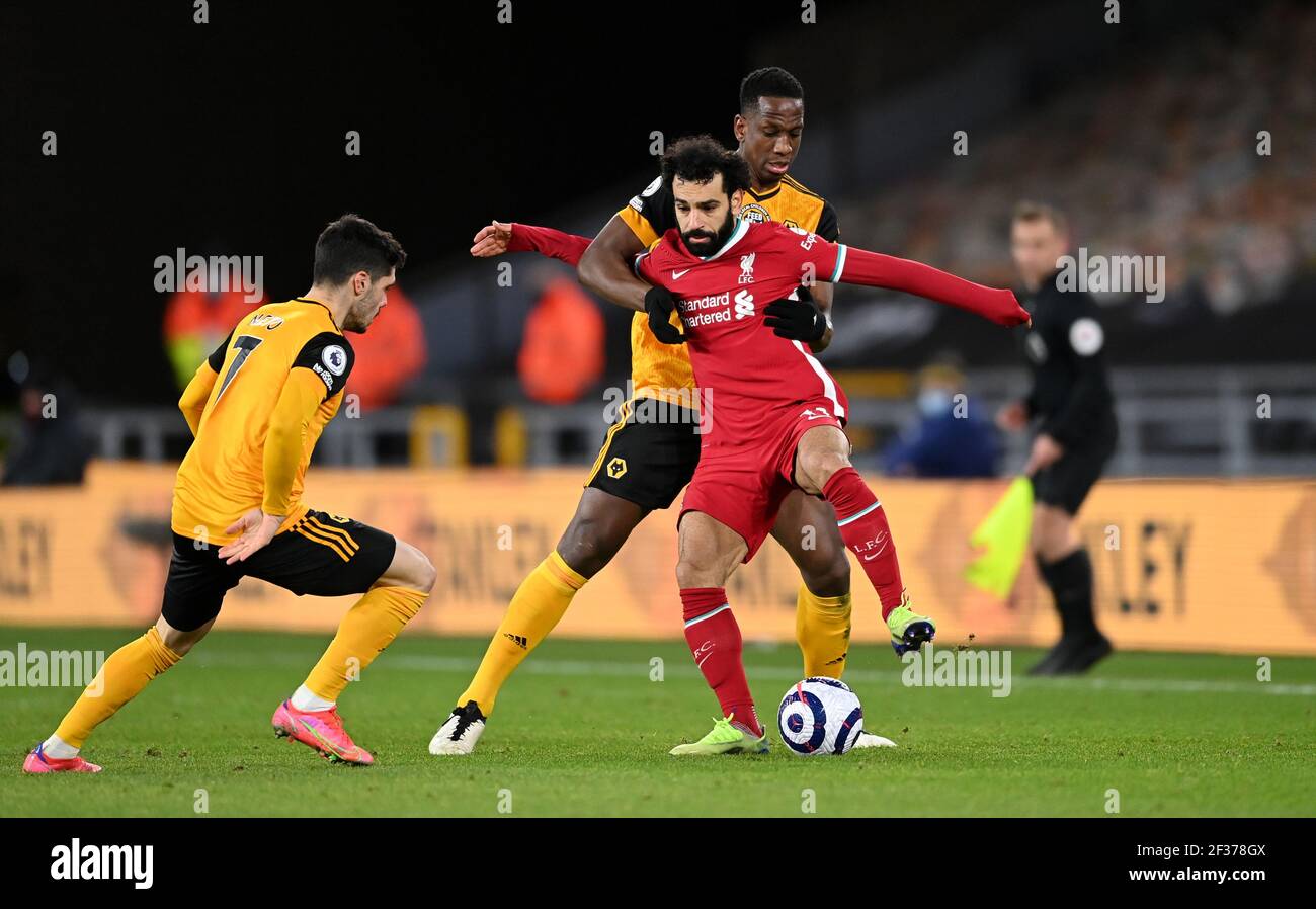 Liverpool's Mohamed Salah (right) battles with Wolverhampton Wanderers ...