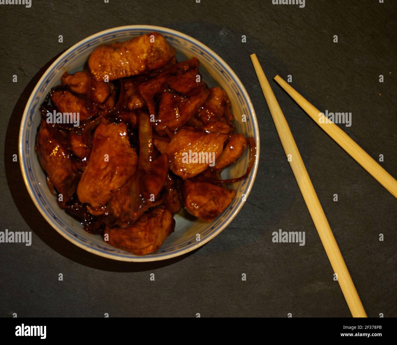 Korean grilled chicken with Asian Chopsticks on black slate board. Top ...