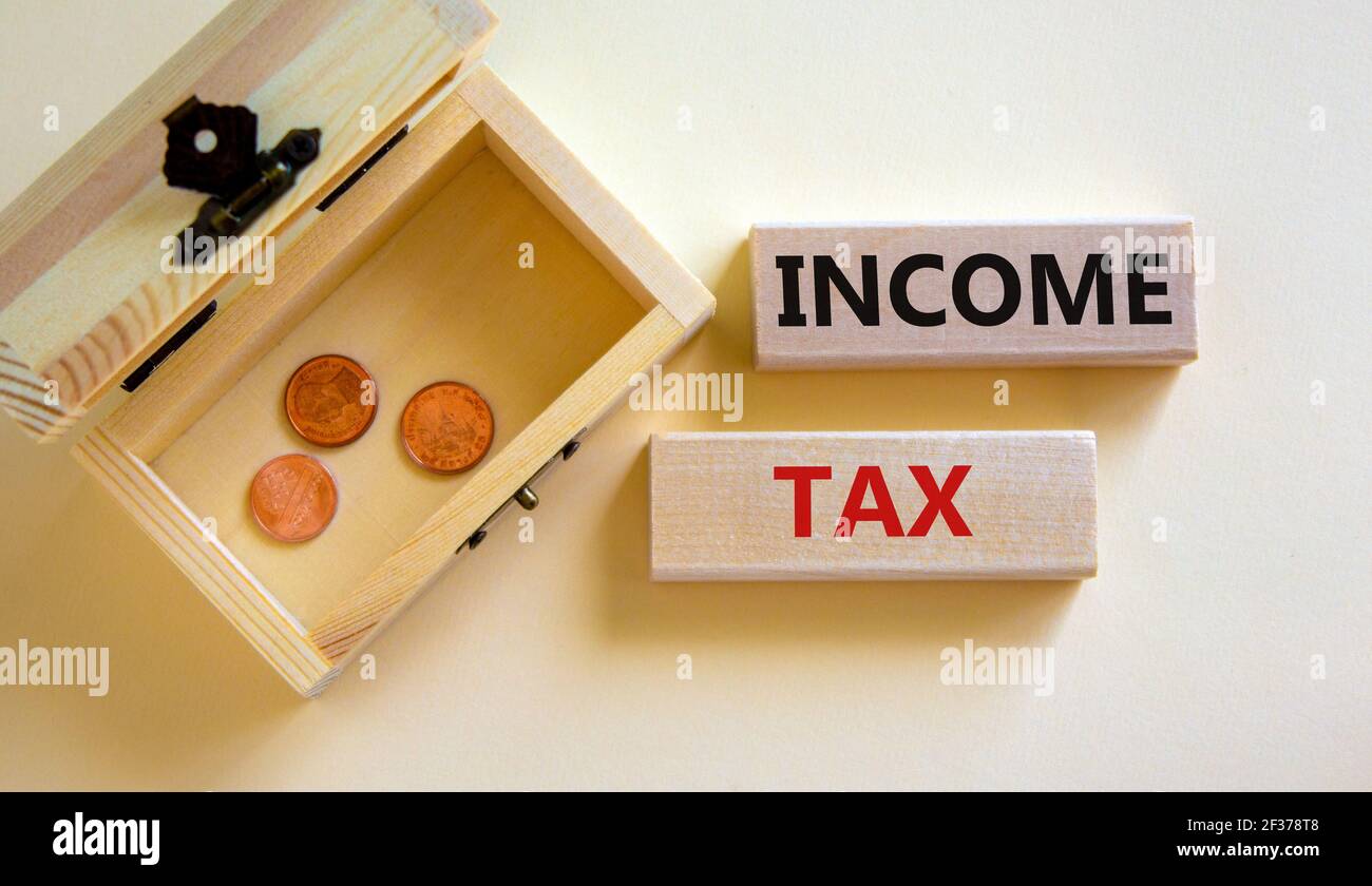 Income tax symbol. Concept words 'income tax' on wooden blocks on a ...