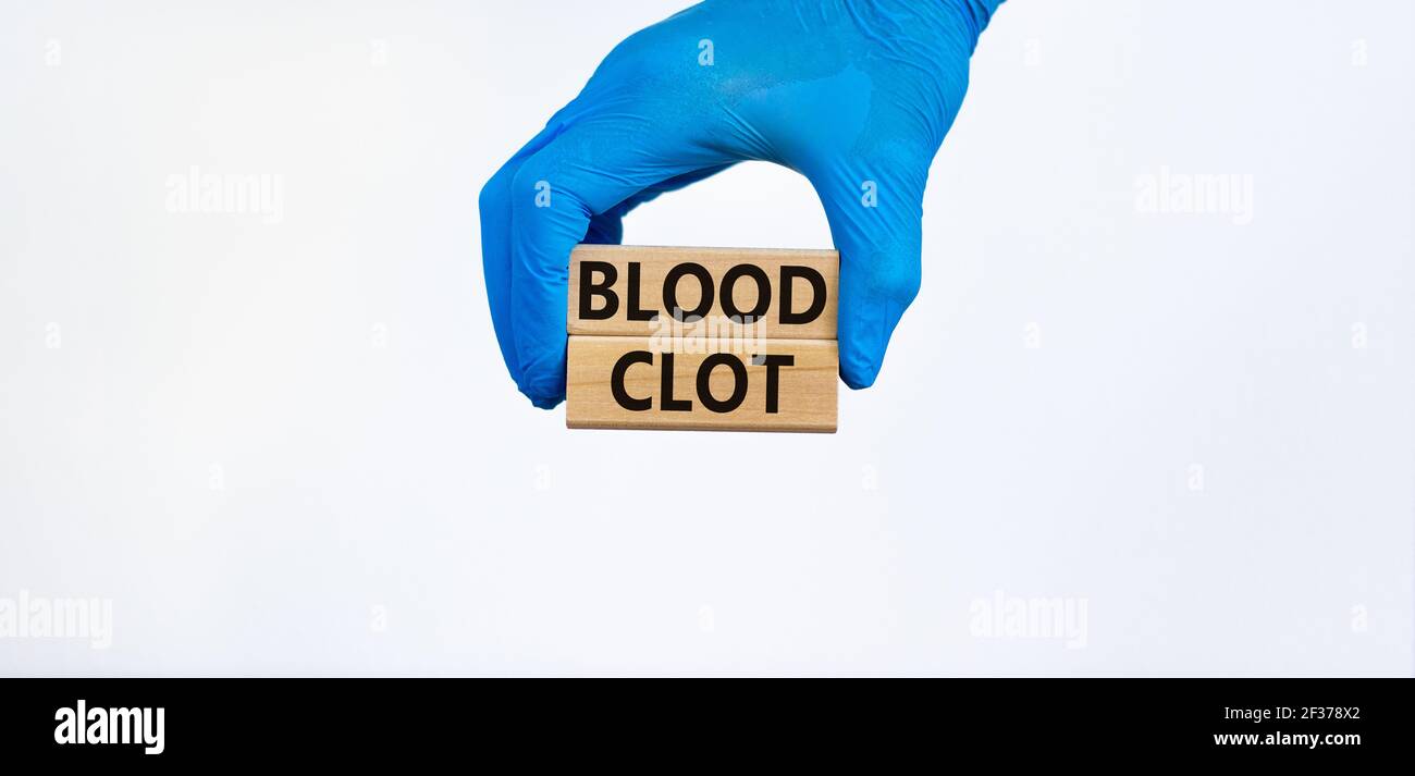Medical and and blood clot symbol. Doctor holds wooden blocks with ...