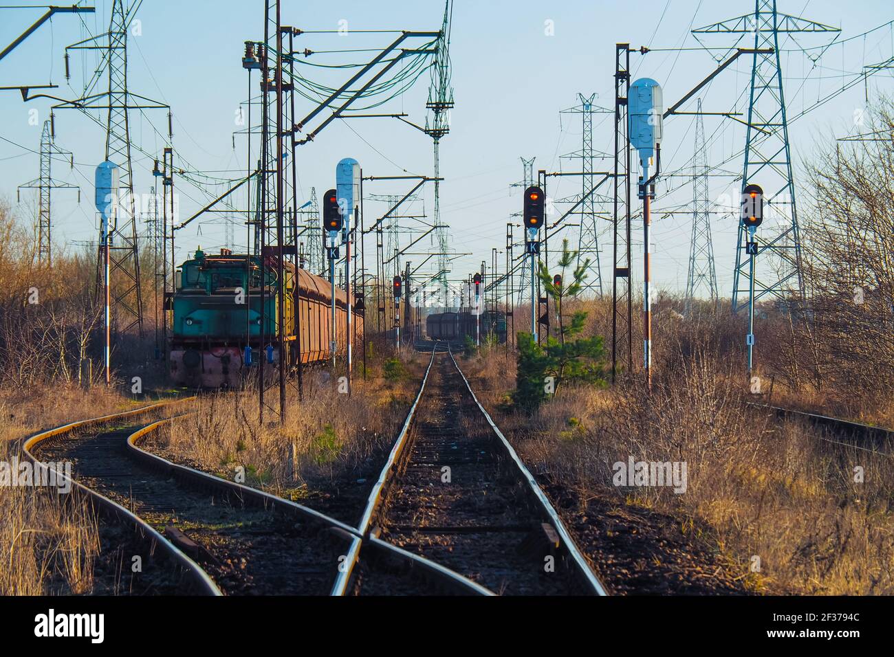 dusty electric freight train and red semaphores Stock Photo - Alamy