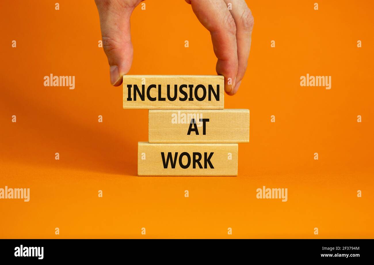Inclusion at work symbol. Wooden blocks with words 'Inclusion at work ...
